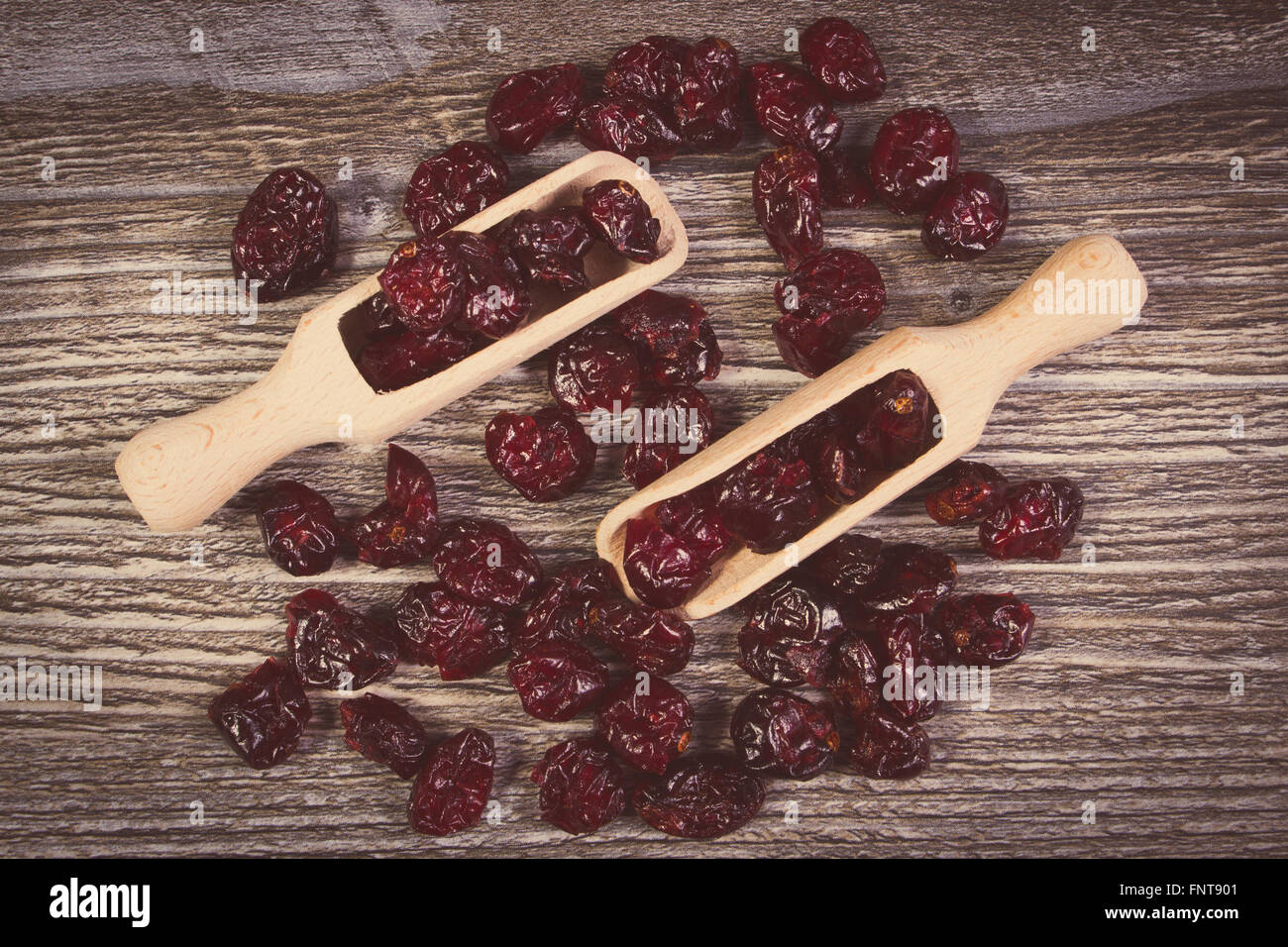 Vintage photo, Heap of red cranberries with spoon on wooden table ...