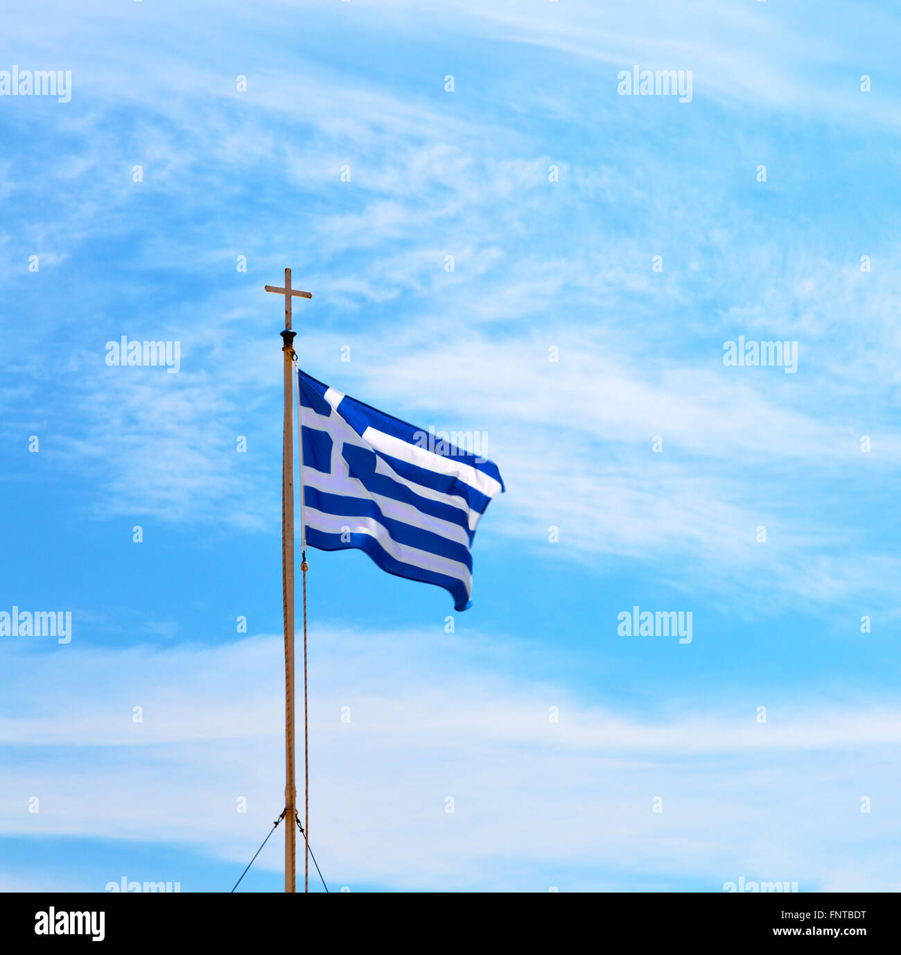 waving greece flag in the blue sky and flagpole Stock Photo - Alamy