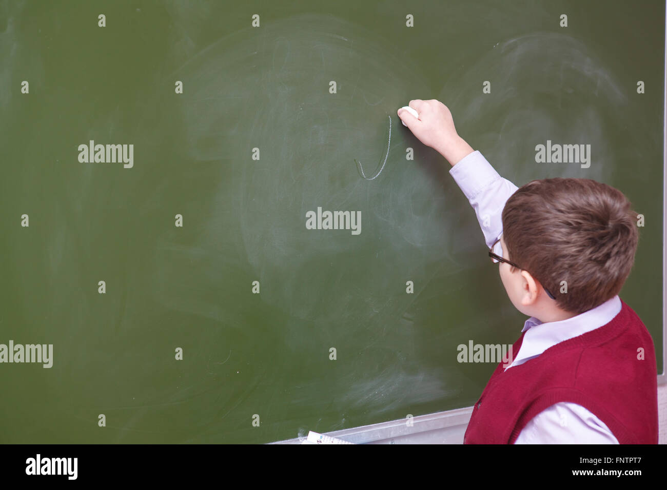 boy writes chalk on blackboard Stock Photo - Alamy