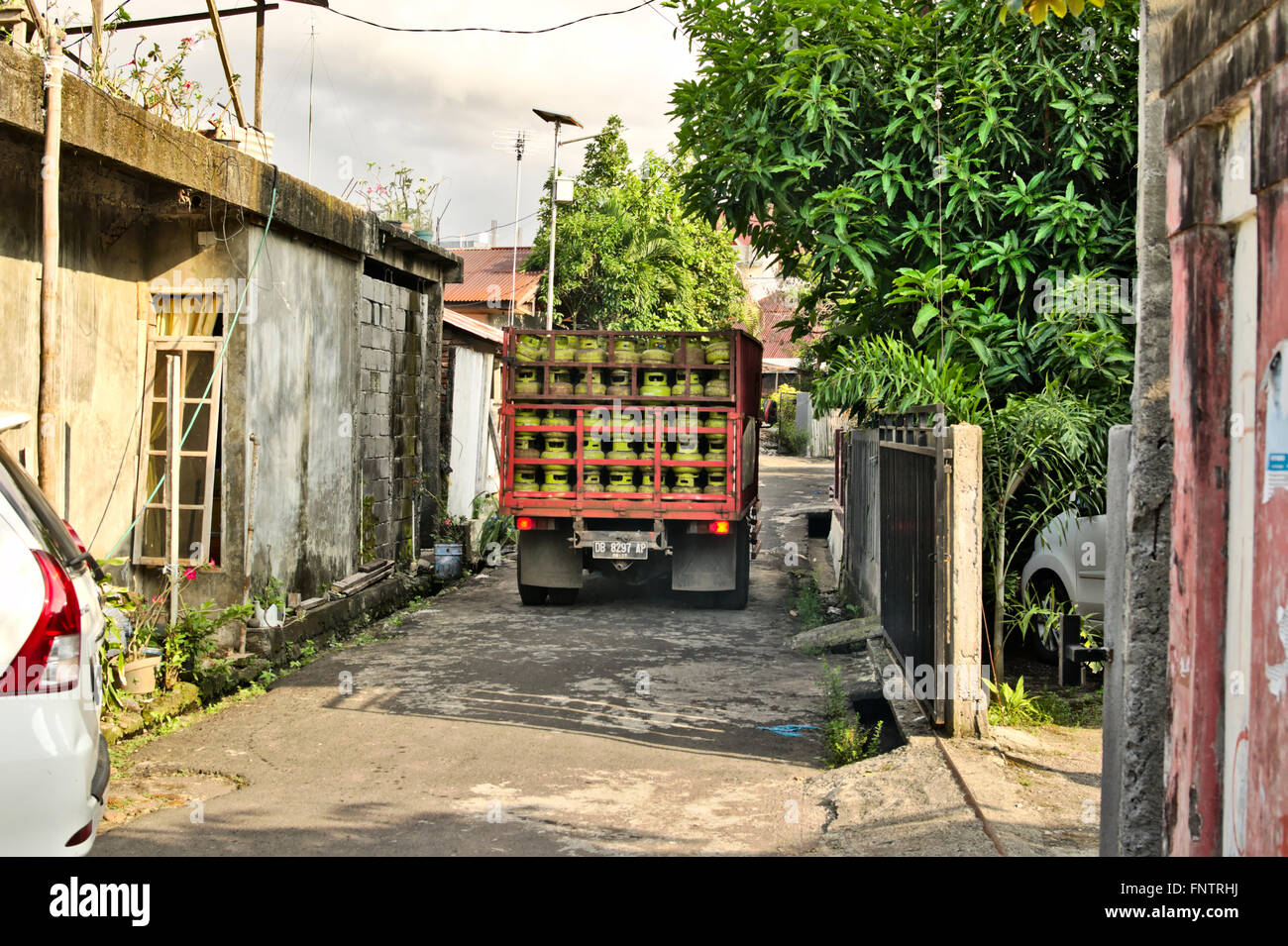A truck filled with small LPG tanks takes up all the room on a narrow ...