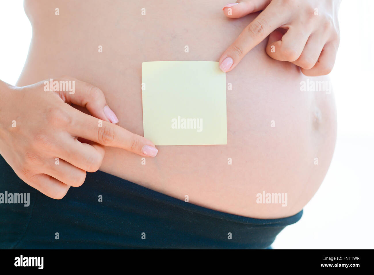 Woman hand posting empty adhesive notes on her pregnancy belly Stock ...