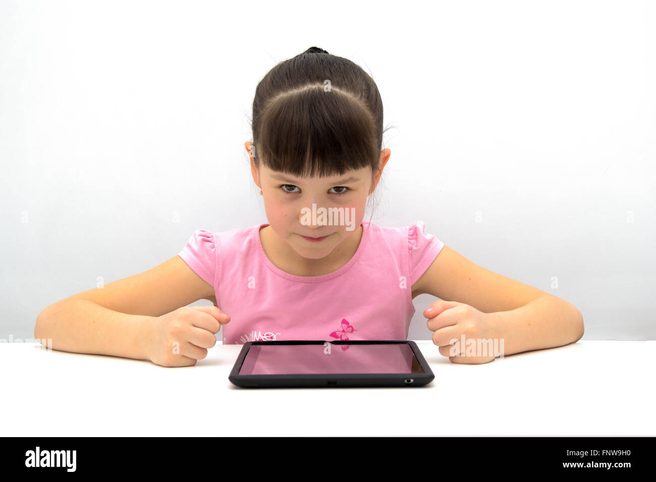 Little girl using a tablet pc Stock Photo - Alamy