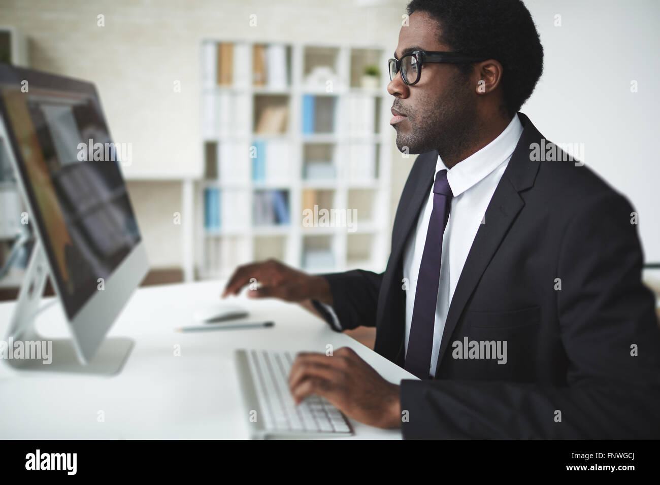 Modern businessman networking in front of computer Stock Photo - Alamy