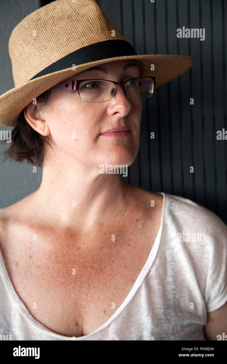 Woman with Straw Hat Indoors Stock Photo - Alamy