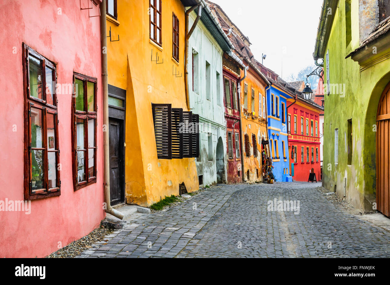 Sighisoara, Romania. Stone paved old streets with colorful houses in ...