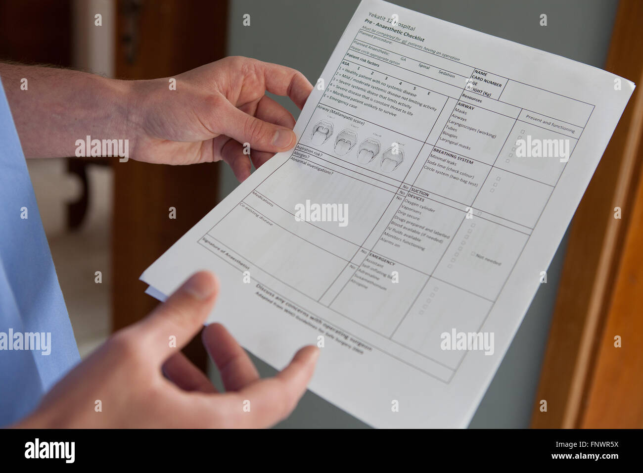 A doctor examines a pre operation check list in a hospital, Ethiopia ...