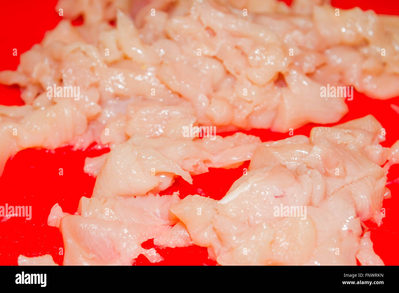Sliced raw pieces of chicken for the filling Stock Photo - Alamy