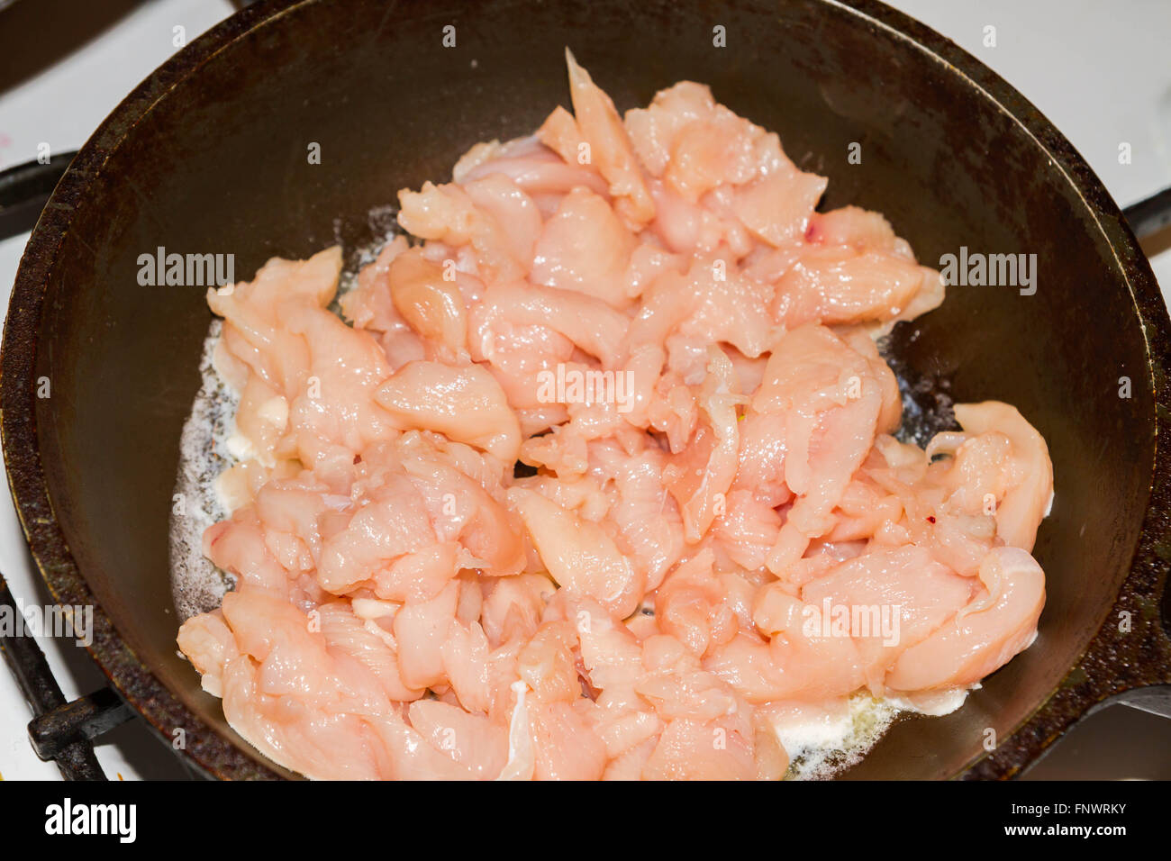 Cooking small pieces of chicken in the pan Stock Photo - Alamy
