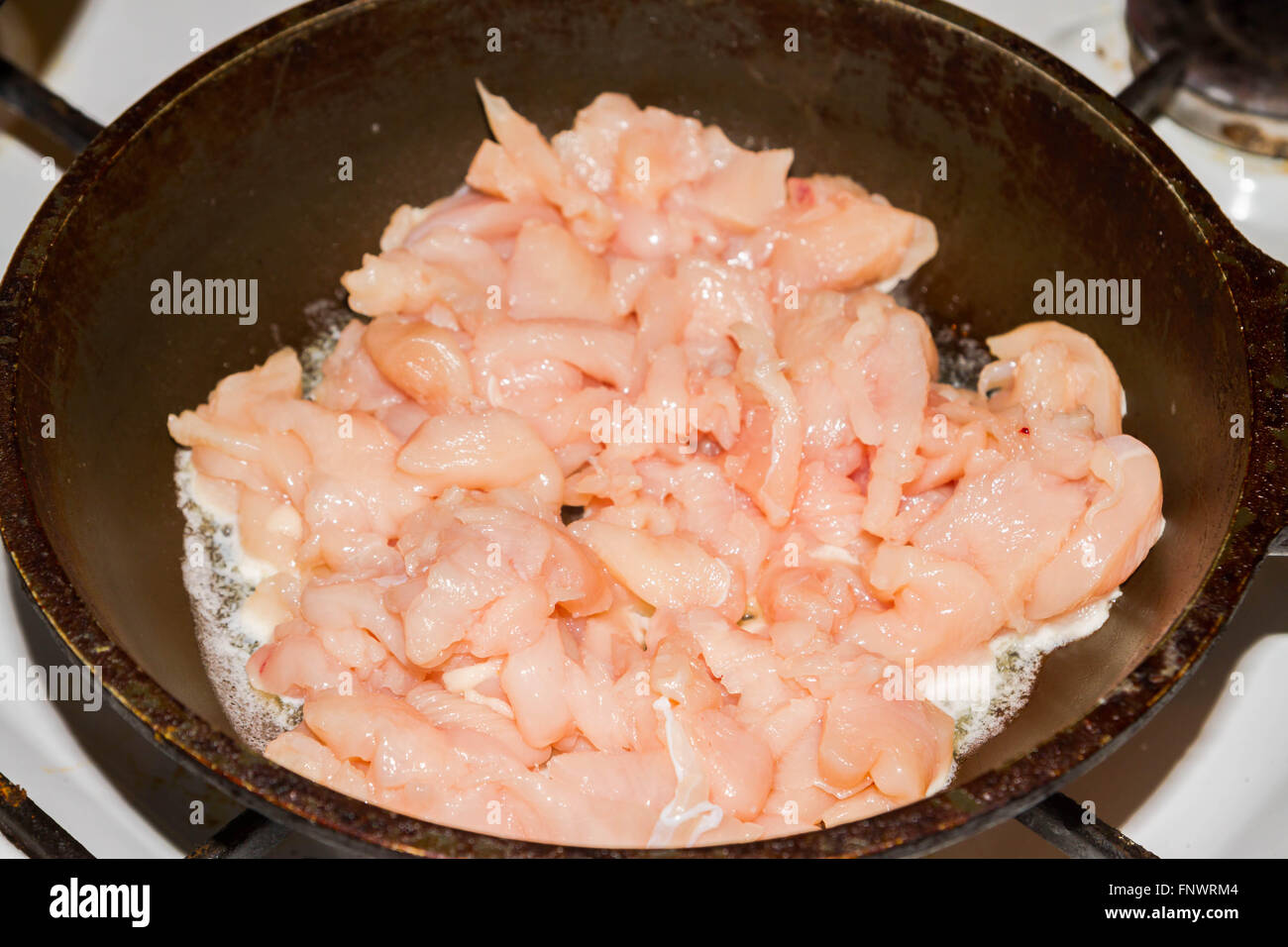 Cooking small pieces of chicken in the pan Stock Photo - Alamy