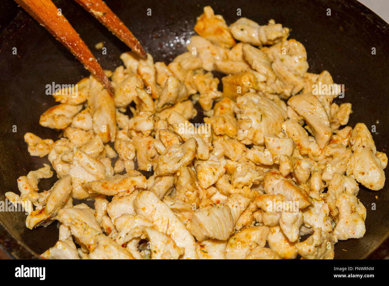 Cooking small pieces of chicken in the pan Stock Photo - Alamy
