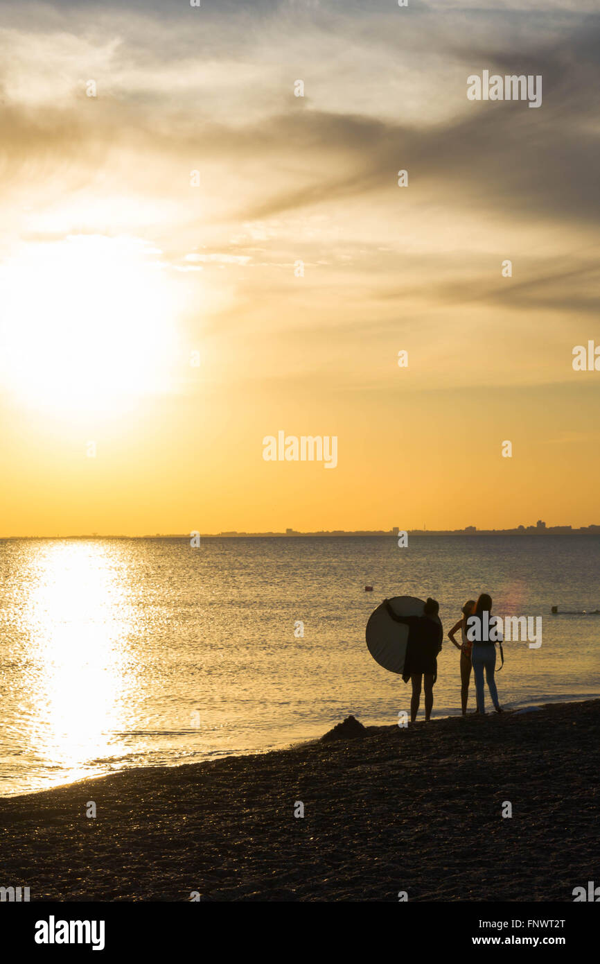 Photoshoot at sunset on the beach Stock Photo - Alamy