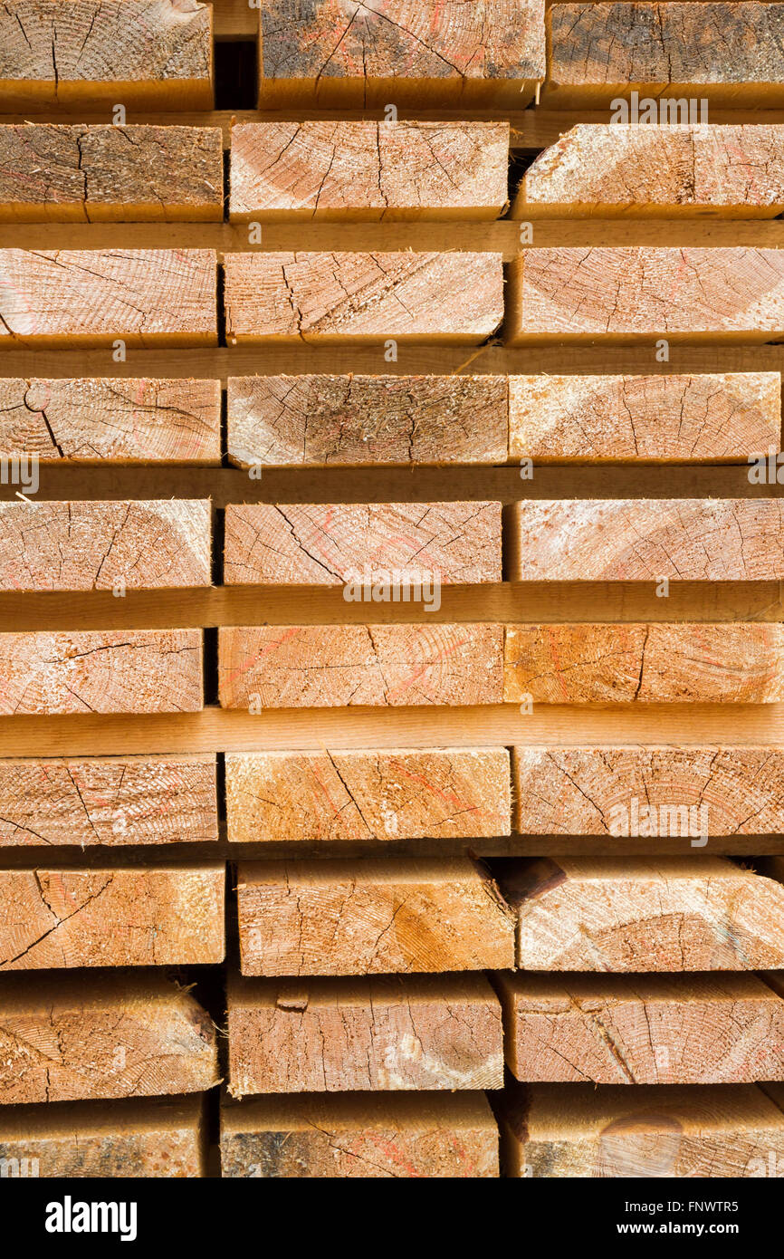 Wooden planks to build a house on a stack of folded construction base ...