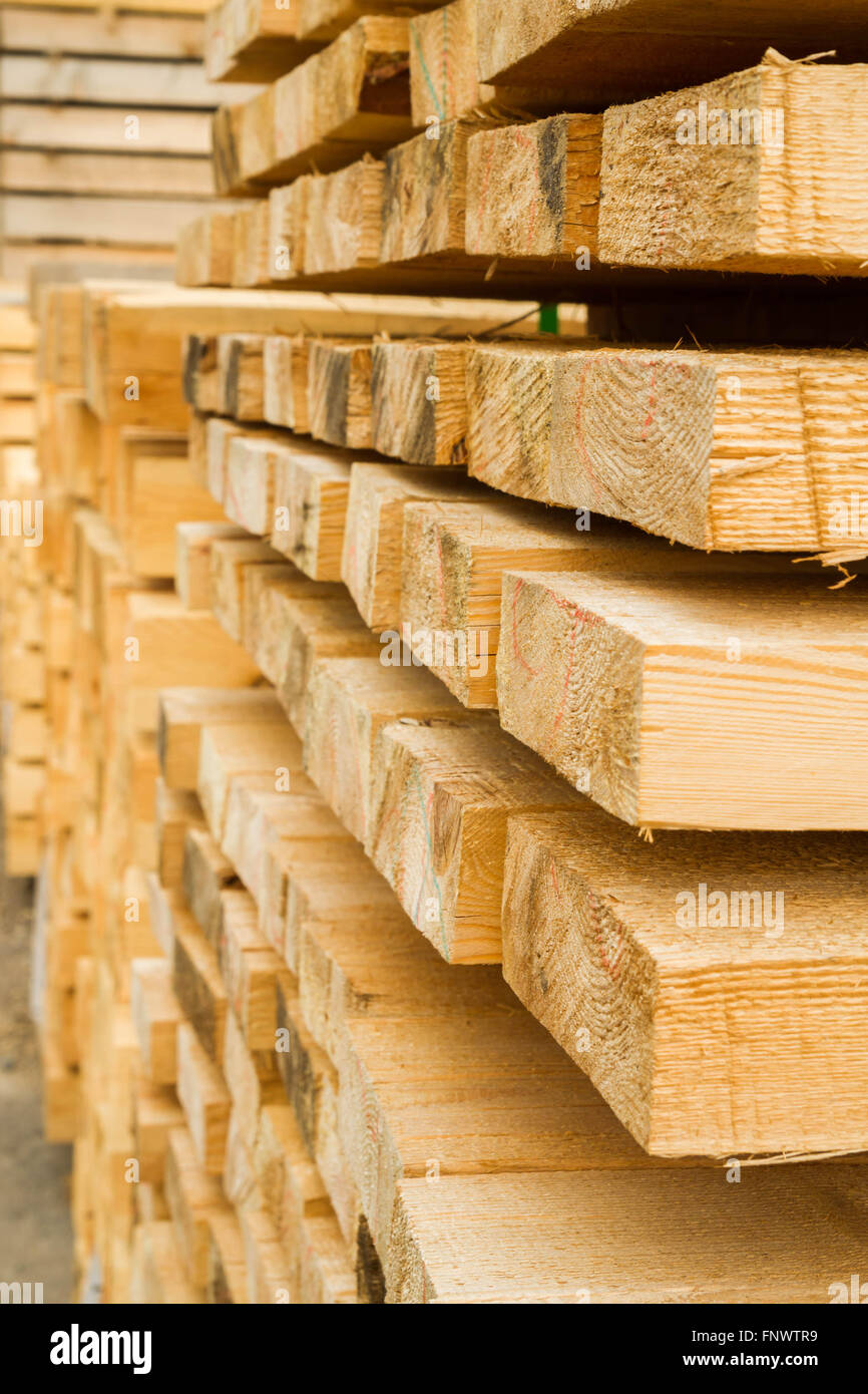 Wooden planks to build a house on a stack of folded construction base ...