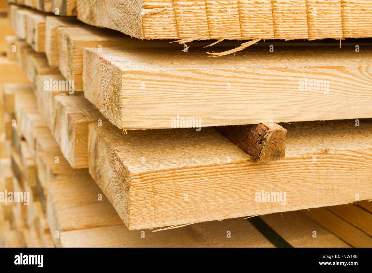 Wooden planks to build a house on a stack of folded construction base ...