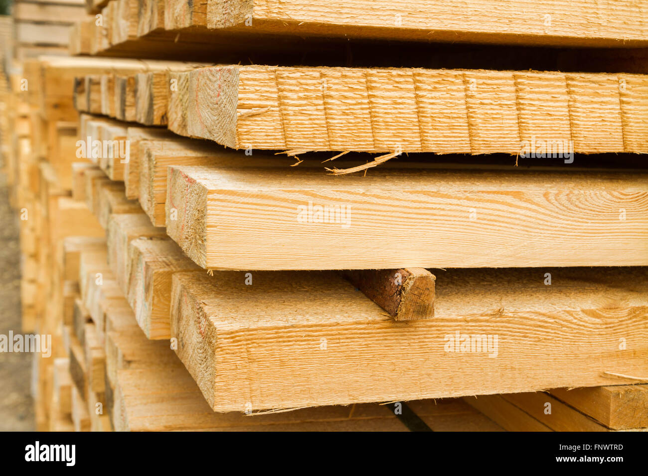 Wooden planks to build a house on a stack of folded construction base ...