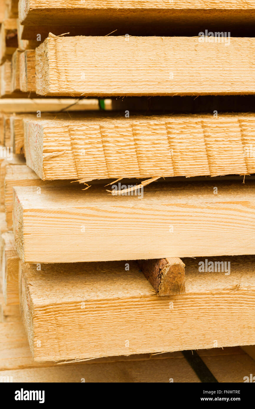 Wooden planks to build a house on a stack of folded construction base ...