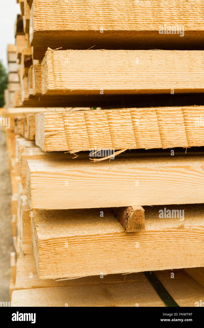 Wooden planks to build a house on a stack of folded construction base ...