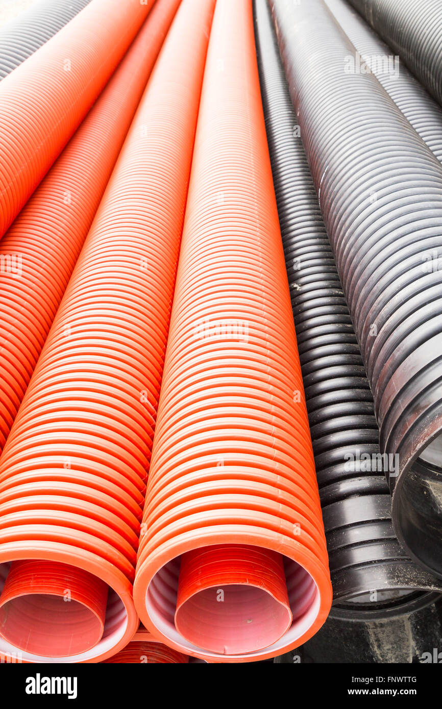 Construction orange and black plastic pipes Stock Photo - Alamy