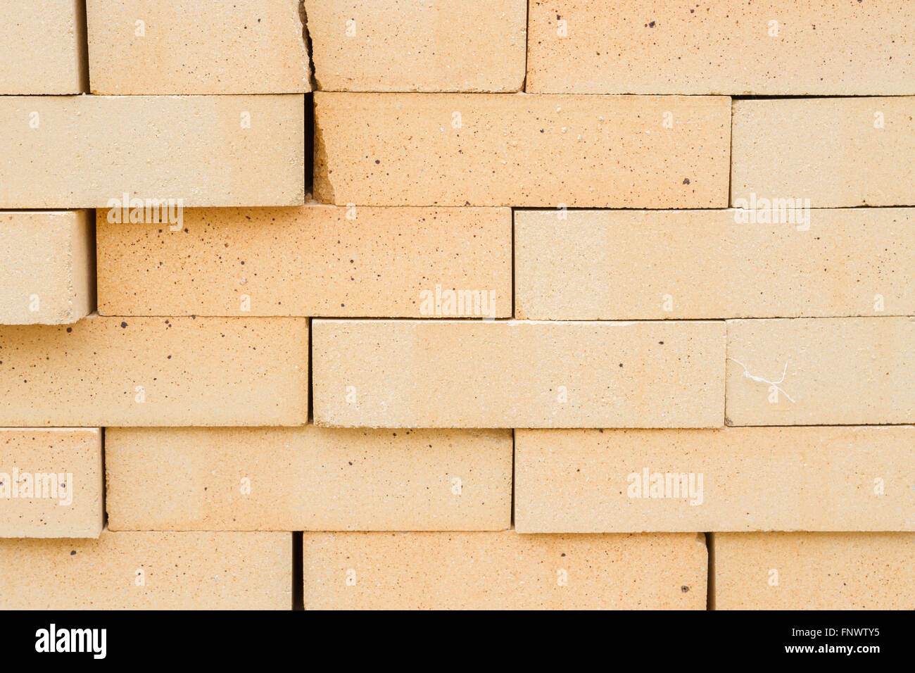 Bricks stacked in a warehouse building base Stock Photo - Alamy