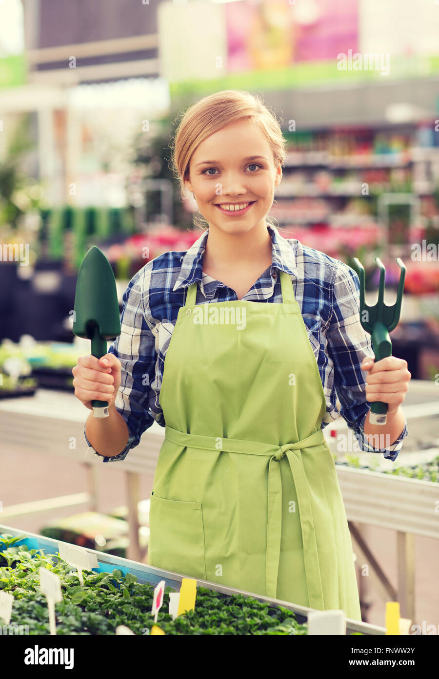 happy woman with gardening tools in greenhouse Stock Photo - Alamy