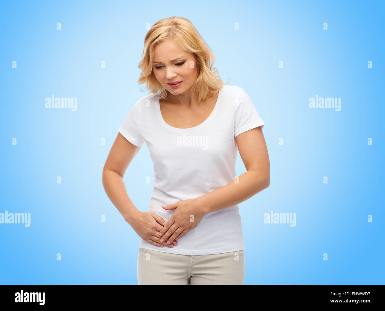 unhappy woman suffering from stomach ache Stock Photo - Alamy
