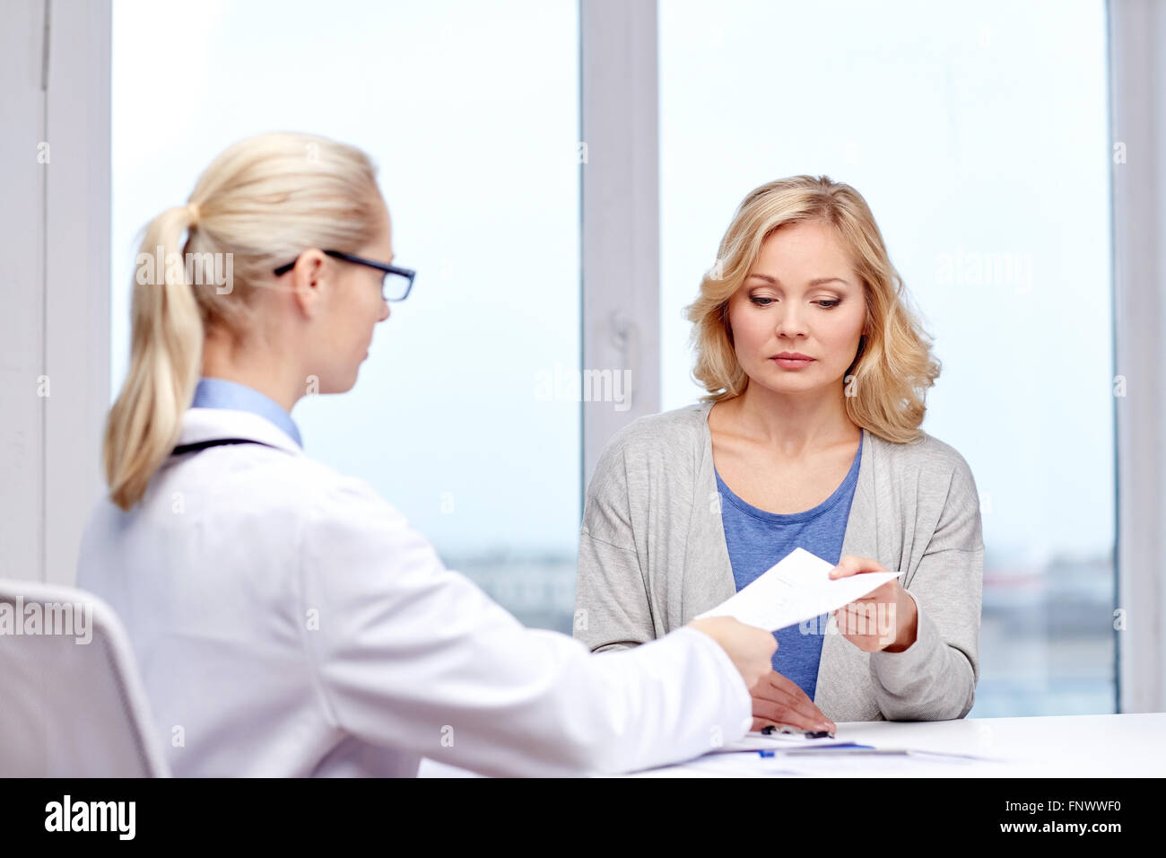 doctor giving prescription to woman at hospital Stock Photo - Alamy