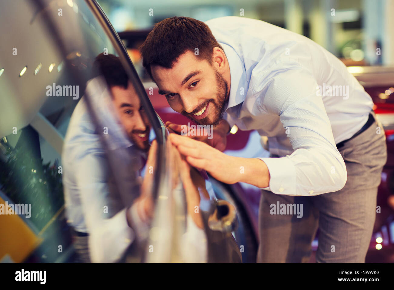 happy man touching car in auto show or salon Stock Photo - Alamy