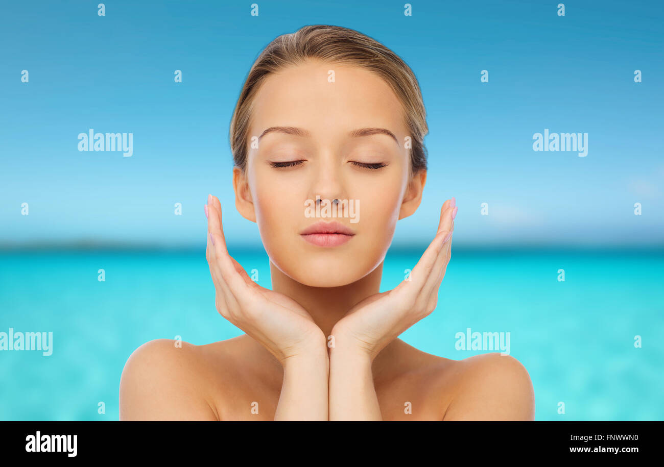 young woman face with hands over sea and sky Stock Photo - Alamy