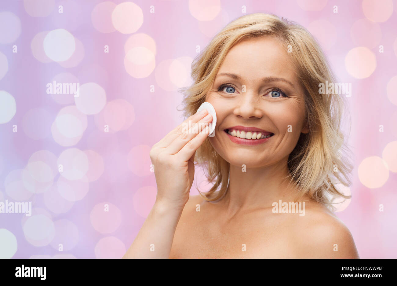 happy woman cleaning face with cotton pad Stock Photo - Alamy