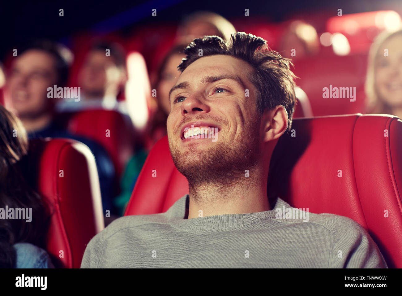 happy young man watching movie in theater Stock Photo - Alamy