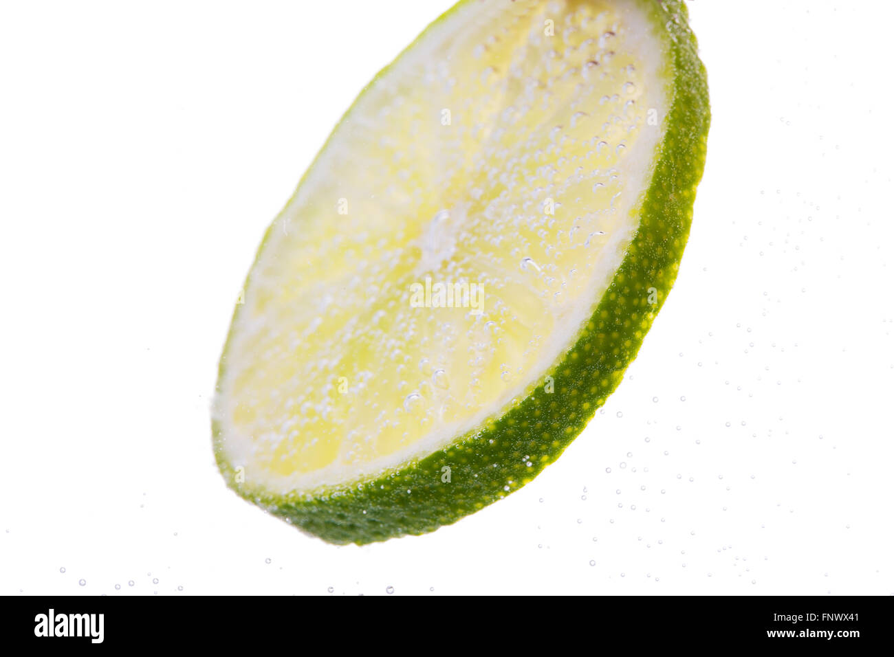 lime slice falling or dipping in water Stock Photo - Alamy