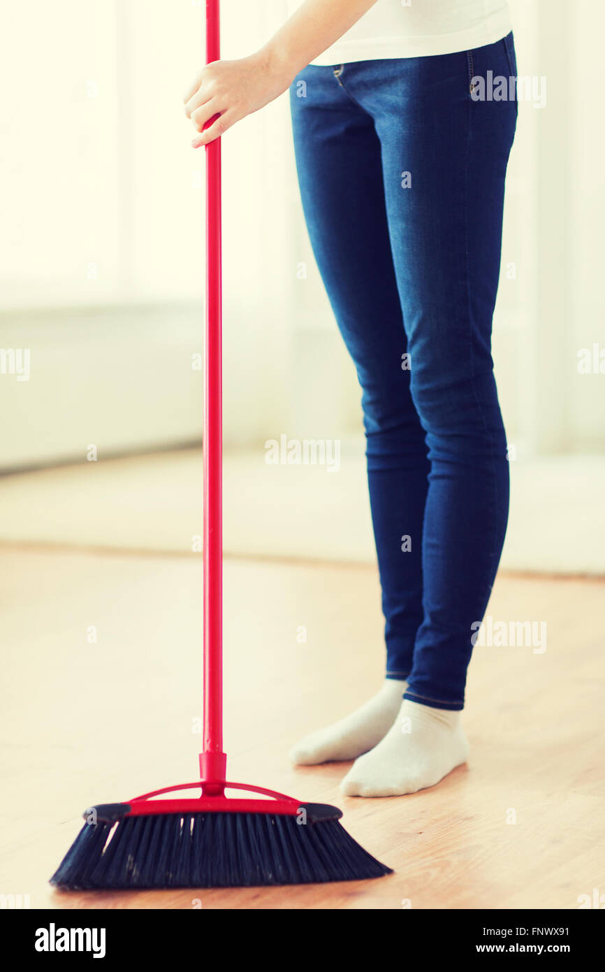 close up of woman legs with broom sweeping floor Stock Photo - Alamy