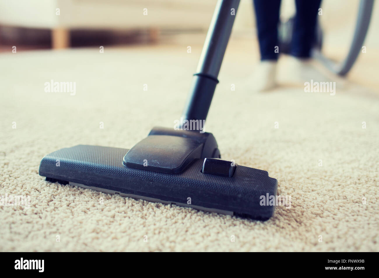 close up of woman legs with vacuum cleaner at home Stock Photo - Alamy