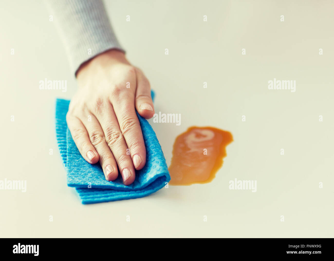 close up of hand cleaning table surface with cloth Stock Photo - Alamy