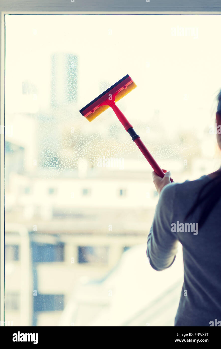 close up of woman cleaning window with sponge Stock Photo - Alamy