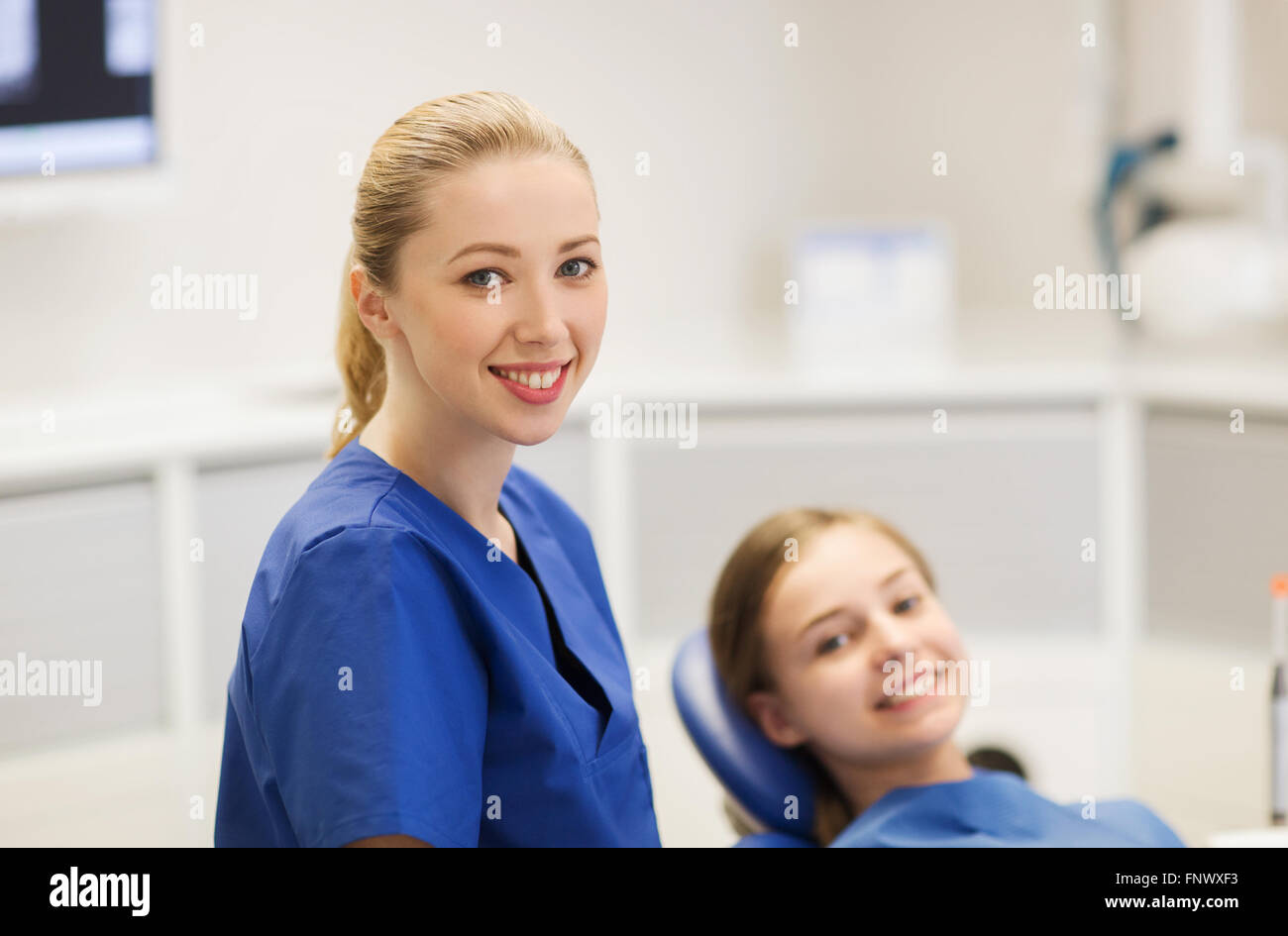 happy female dentist with patient girl at clinic Stock Photo - Alamy