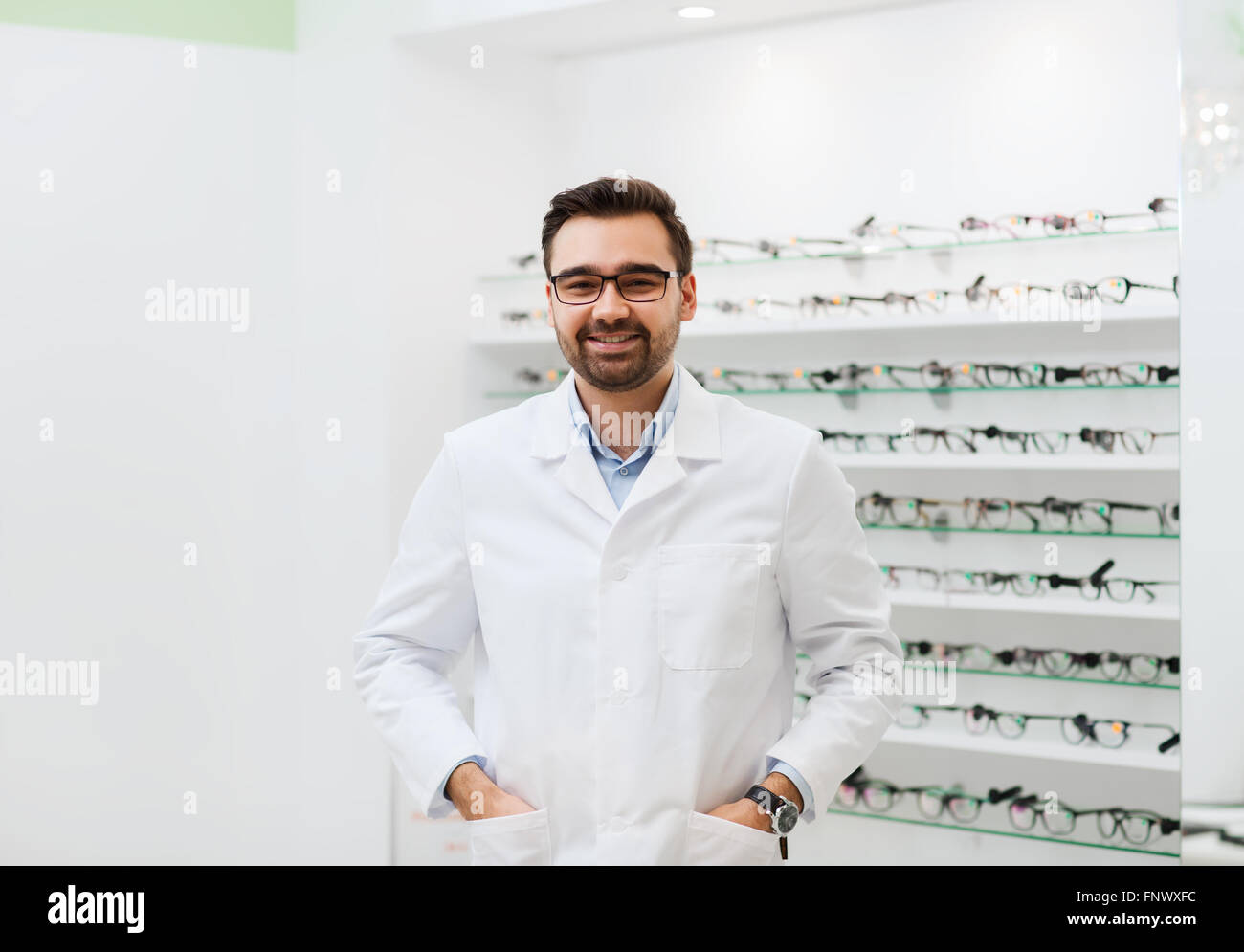 man optician in glasses and coat at optics store Stock Photo - Alamy