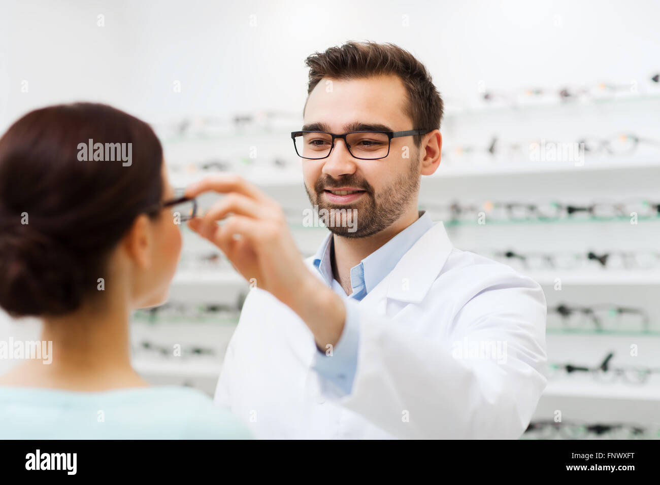 Woman putting eyeglasses hi-res stock photography and images - Alamy