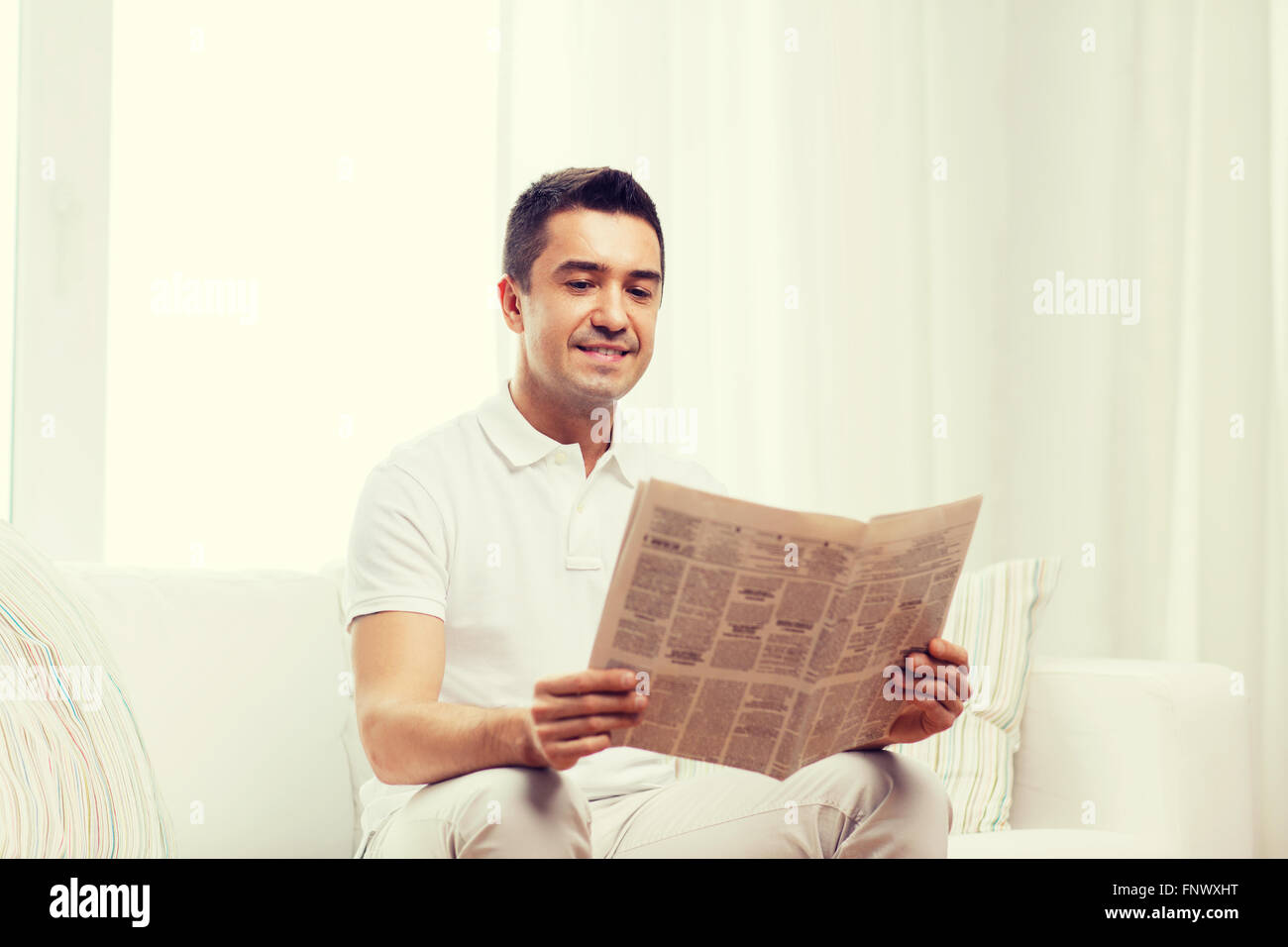 happy man reading newspaper at home Stock Photo - Alamy