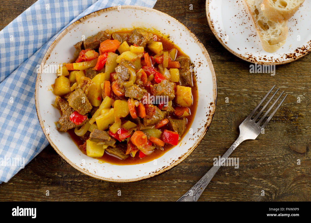 Beef stew with vegetables on rustic wooden table. Top view Stock Photo ...