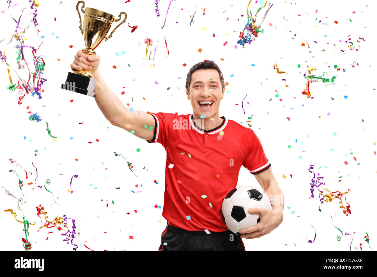 Joyful football player holding a gold trophy and celebrating with ...