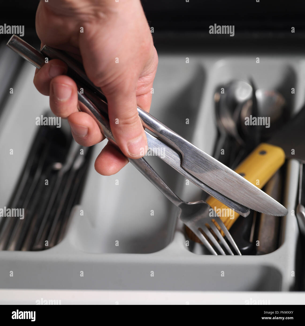 Hand With Silverware Stock Photo - Alamy