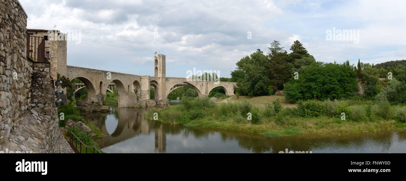 Scenic panoramic view of ancient bridge across Fluvia River in medieval ...