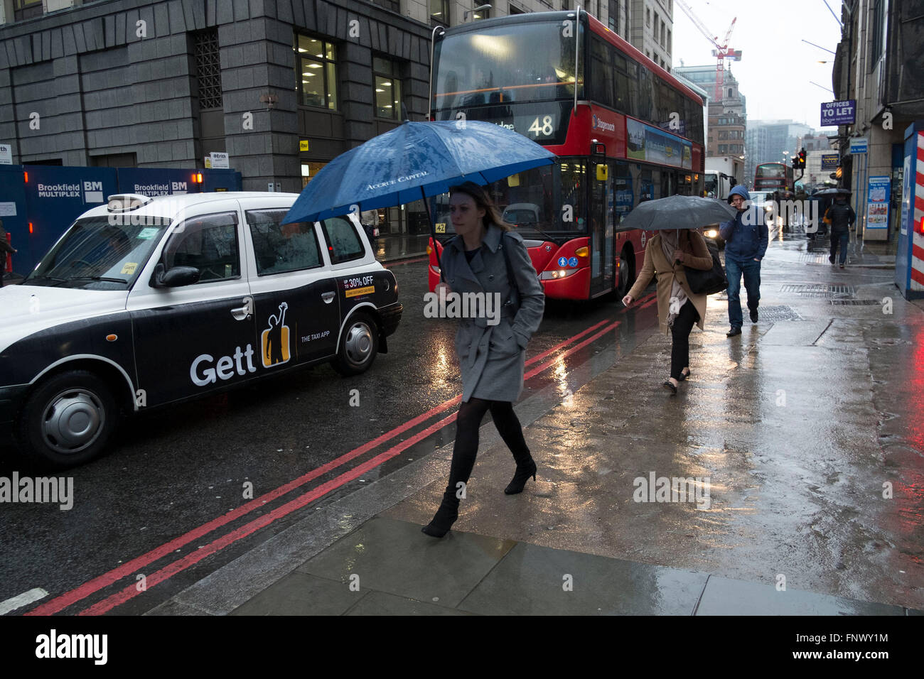 People out and about in the rain in the City of London, England, UK ...