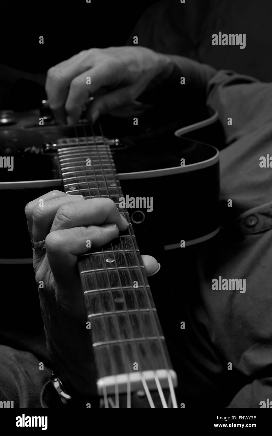 Practicing steel string guitar at home- focus on left hand Stock Photo ...