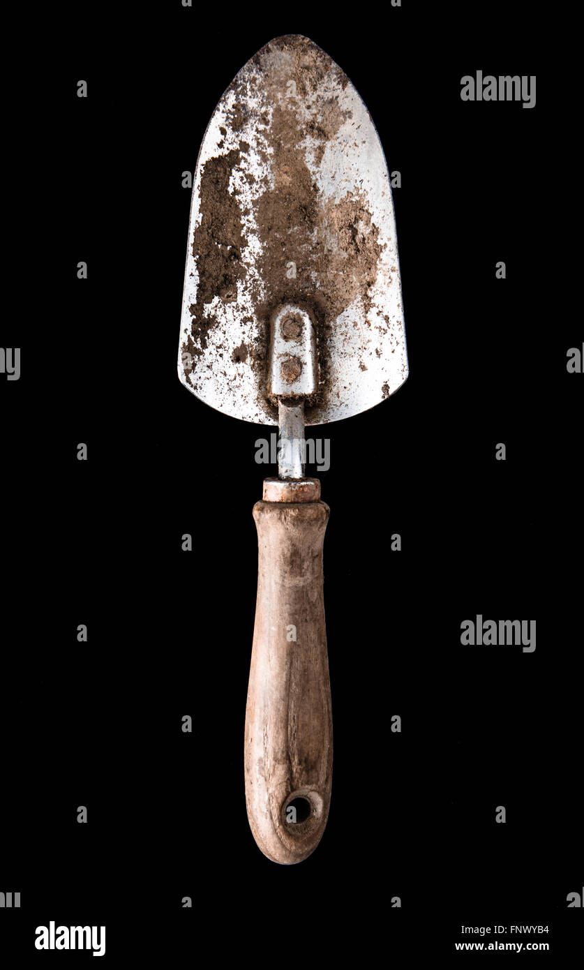 Rusty and dirty Garden Trowel with a Wood Handle isolated on a Black ...