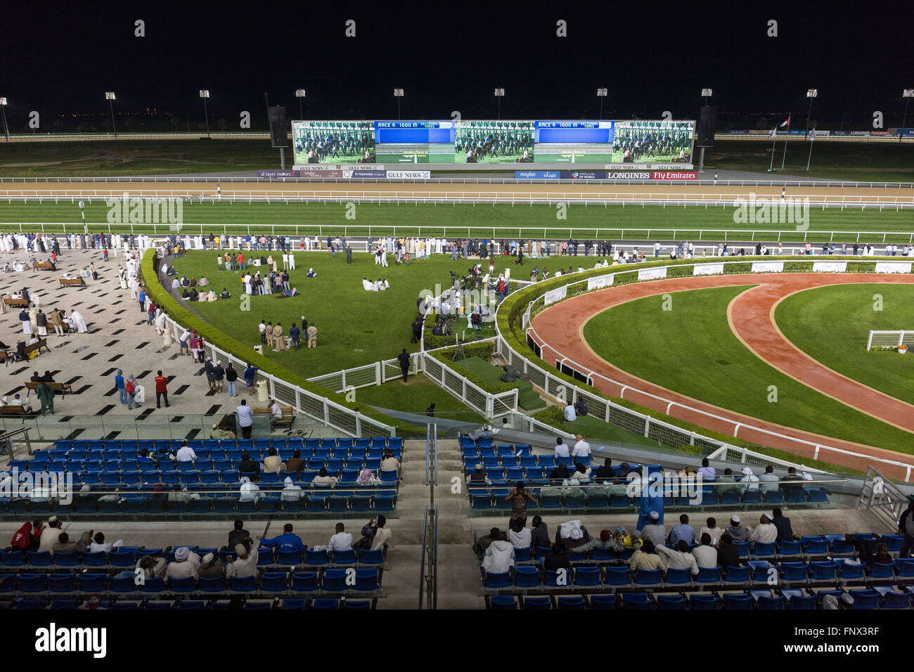 Spectators watching horse racing at The Meydan, Dubai UAE Stock Photo ...