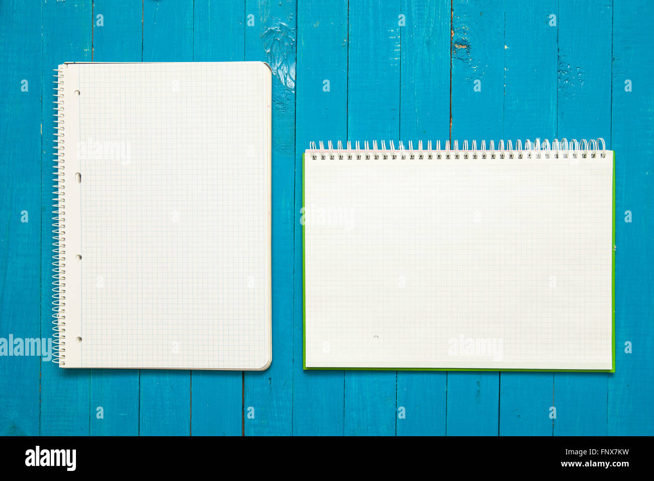 Two open notebook on a blue wooden background Stock Photo - Alamy