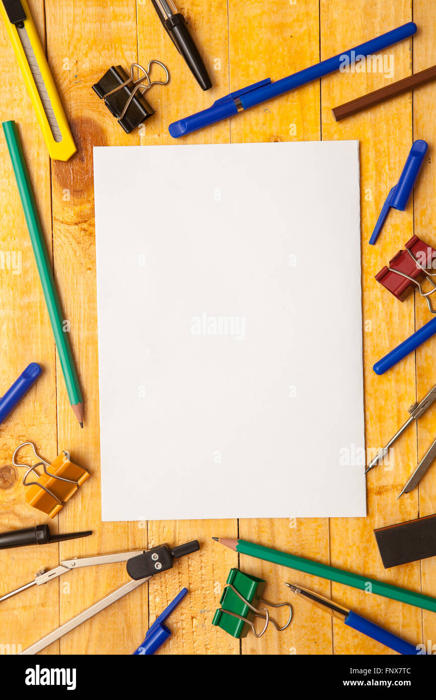 sheet of paper with compass pencil and eraser on a wooden backgr Stock ...