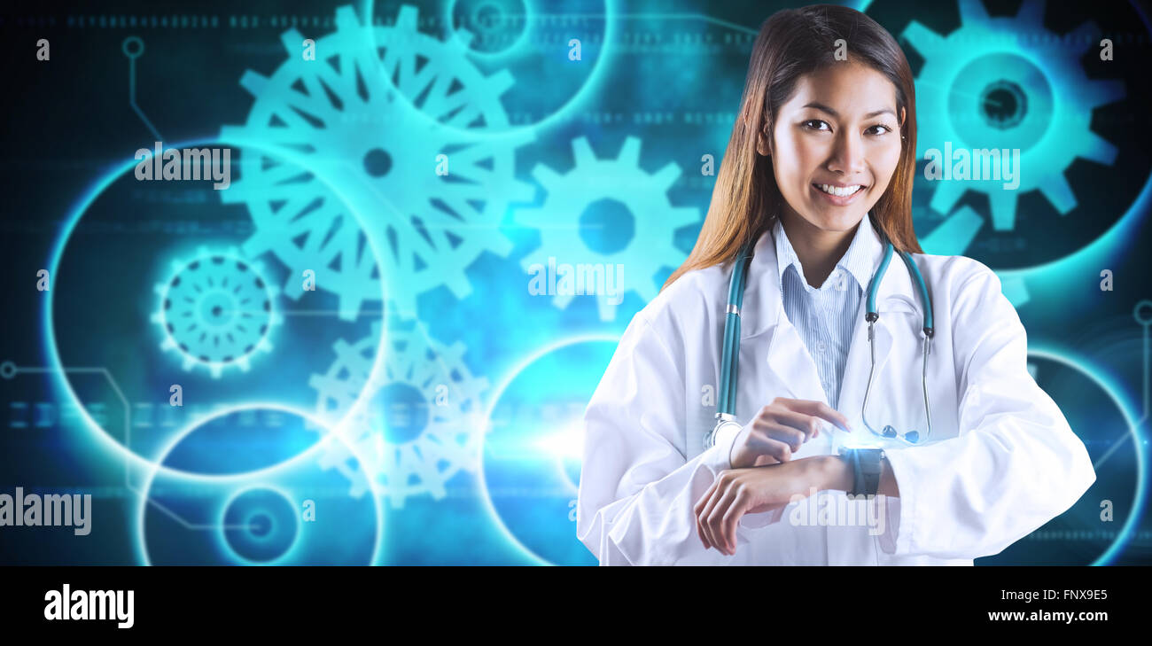 Composite image of asian doctor using her smart watch Stock Photo - Alamy